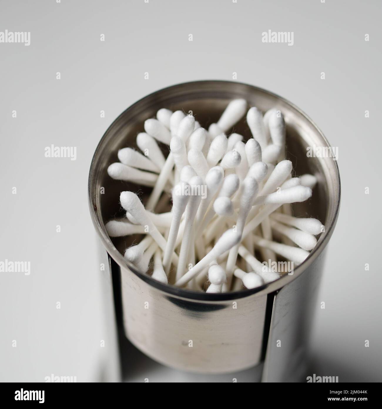 A vertical closeup of cotton buds in a metal container Stock Photo - Alamy