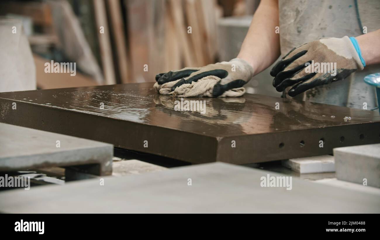 A man worker washing a concrete slab Stock Photo - Alamy