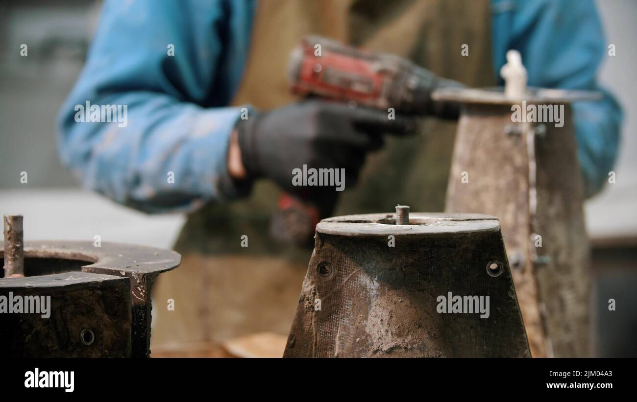 Concrete industry - man working with concrete things in the workshop ...