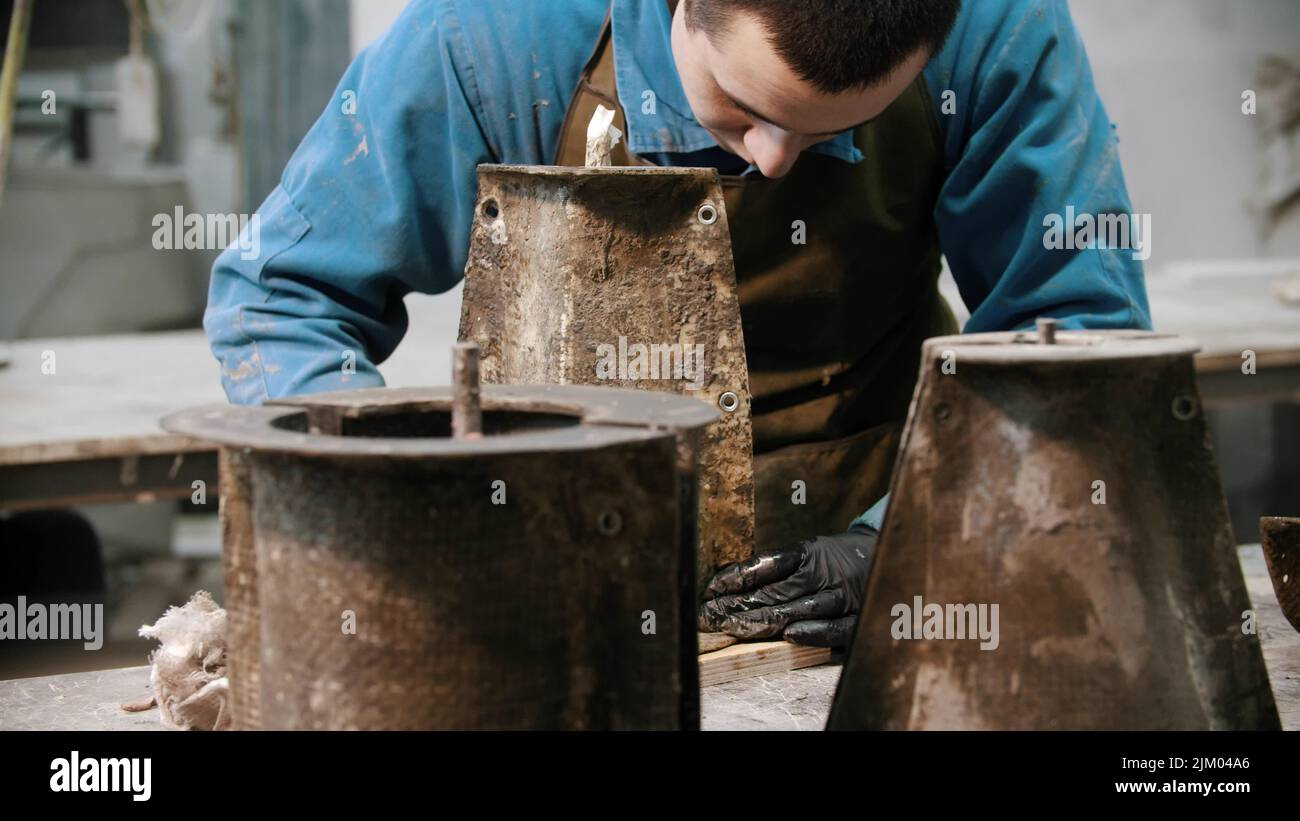 Concrete industry - man working with concrete details in the workshop ...