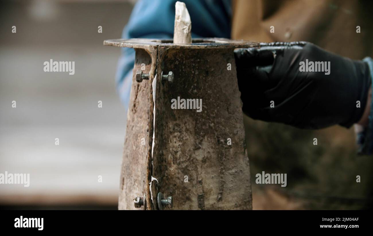 Concrete industry - man worker trying to connect two parts of one ...