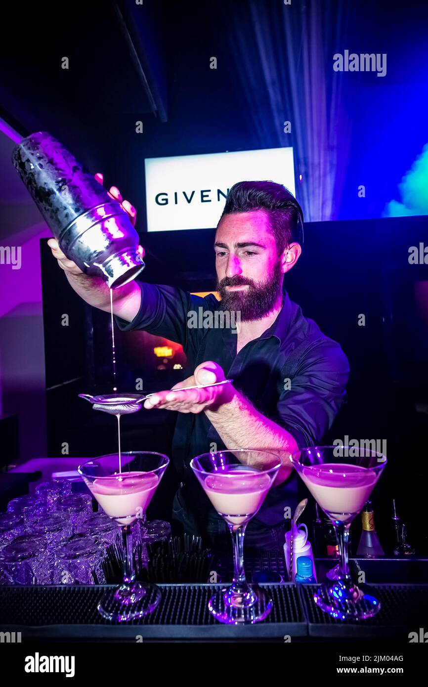 A vertical shot of a barman making drinks at a party in Johannesburg ...