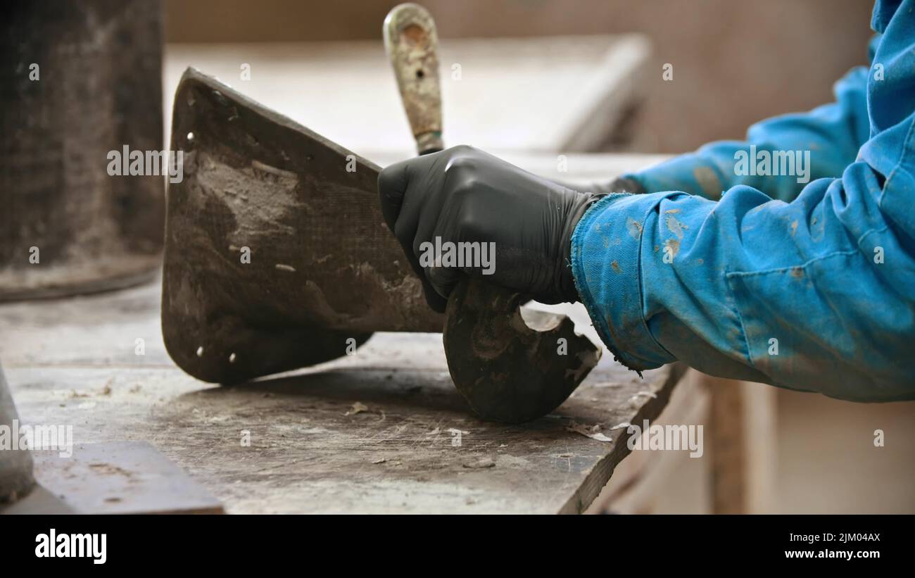 Concrete industry - man worker cleaning the form for concrete casting ...