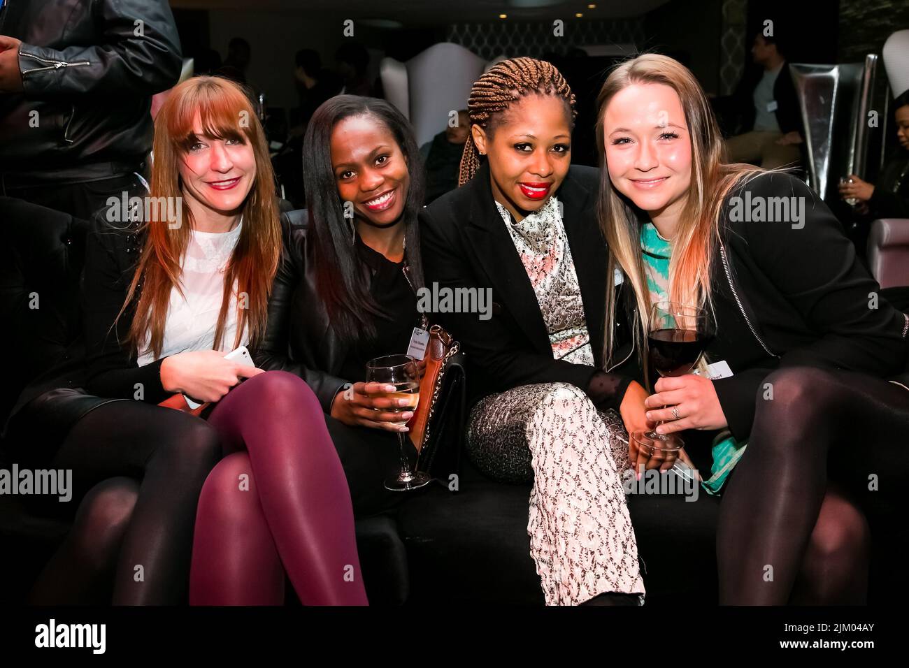 A group of multiracial women at a cocktail party in Johannesburg, South ...