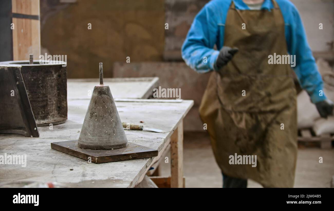 Concrete industry in workshop - worker preparing the form for working ...