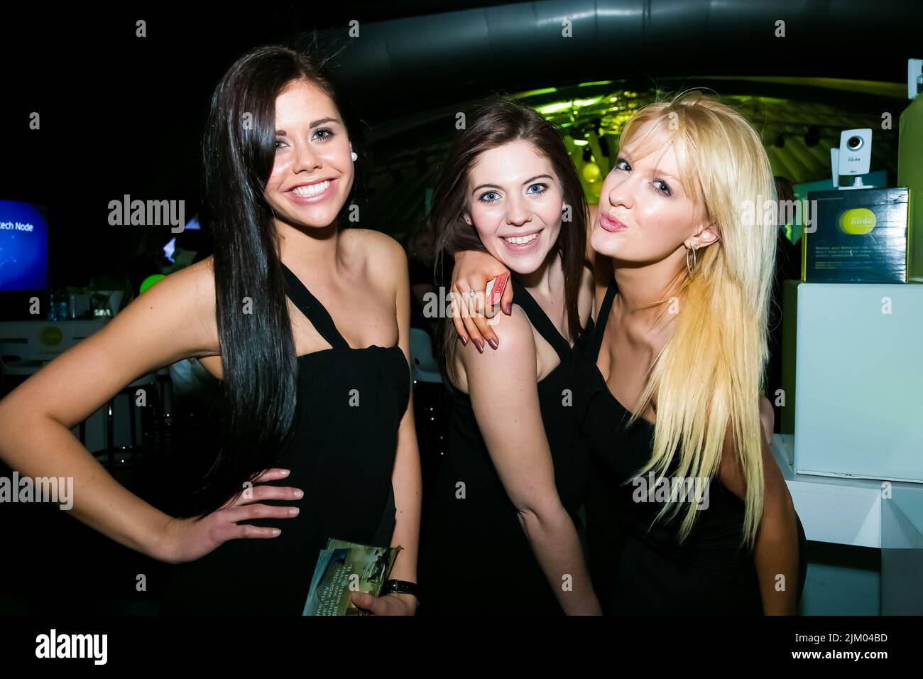 The beautiful female hostesses posing for pictures at a cocktail party ...