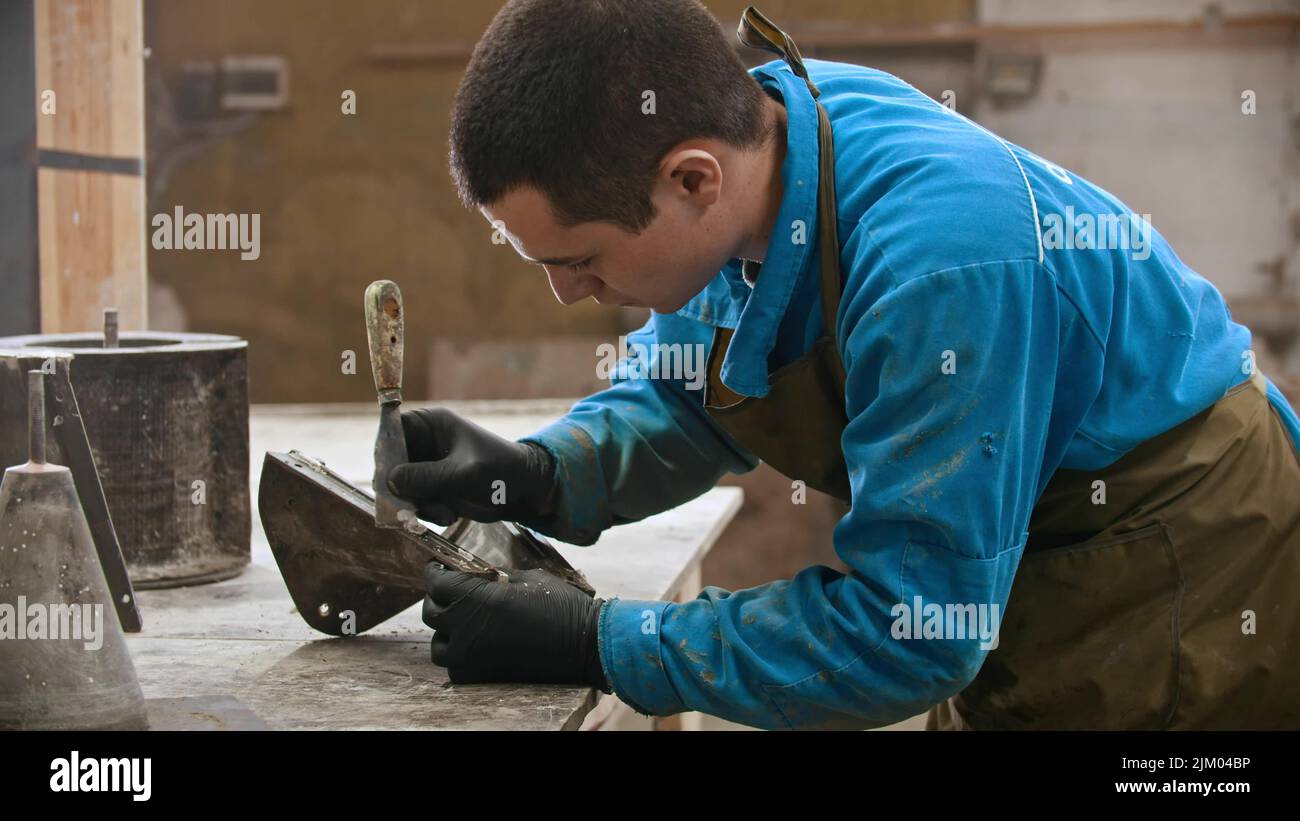 Concrete industry - worker cleaning the form for concrete casting out ...