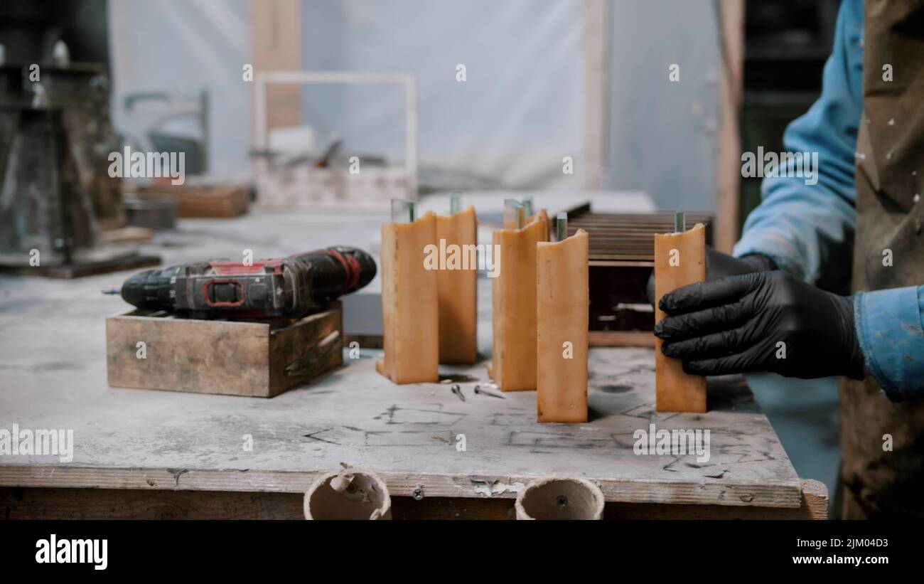 Concrete industry - worker making a souvenir statue using concrete and ...