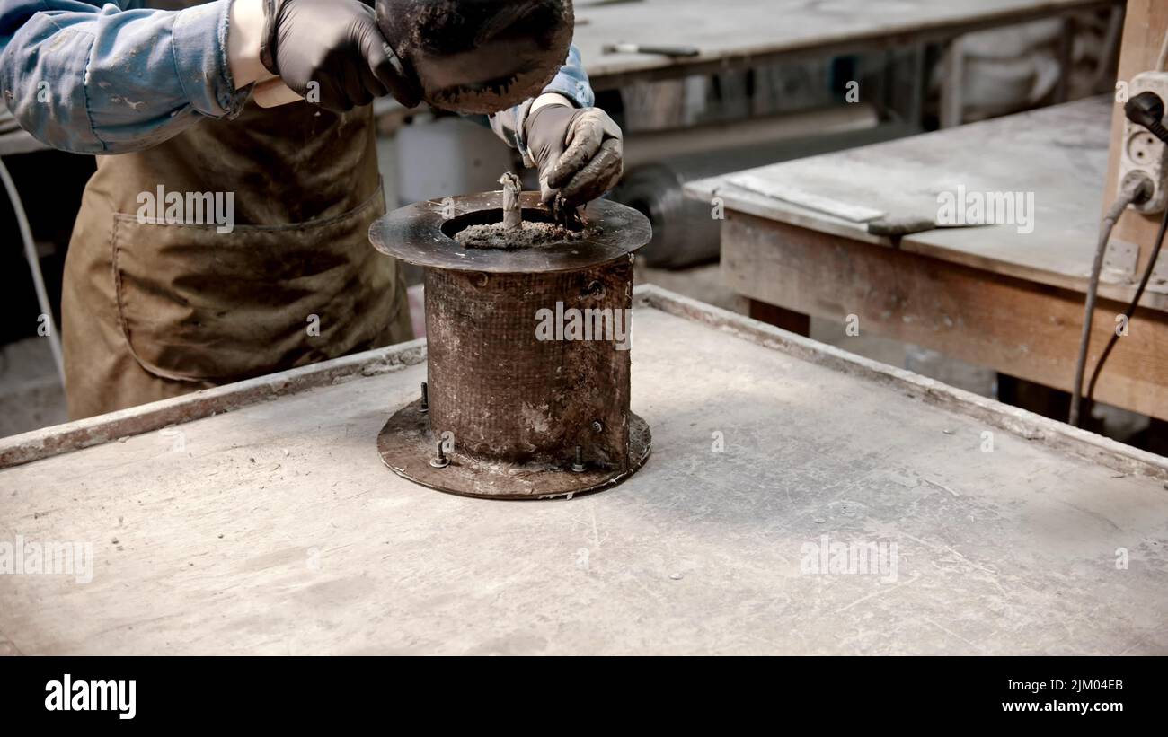 Concrete industry - man worker putting concrete in the form Stock Photo ...