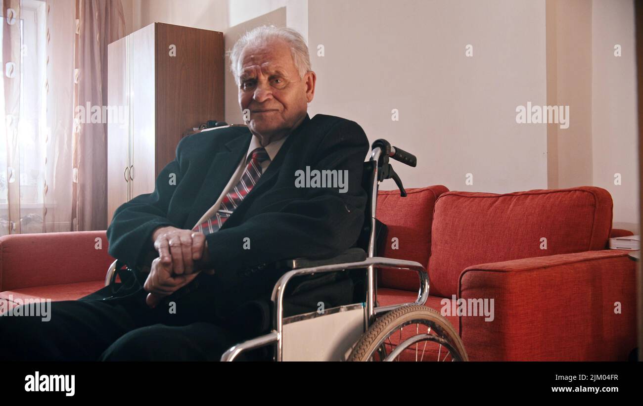 Elderly grandfather - smiling grandfather sitting in a wheelchair Stock ...
