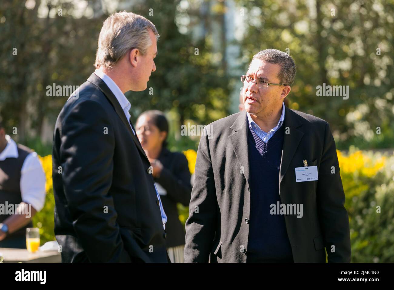 A closeup of two delegates discussing at an outdoor business meeting in ...