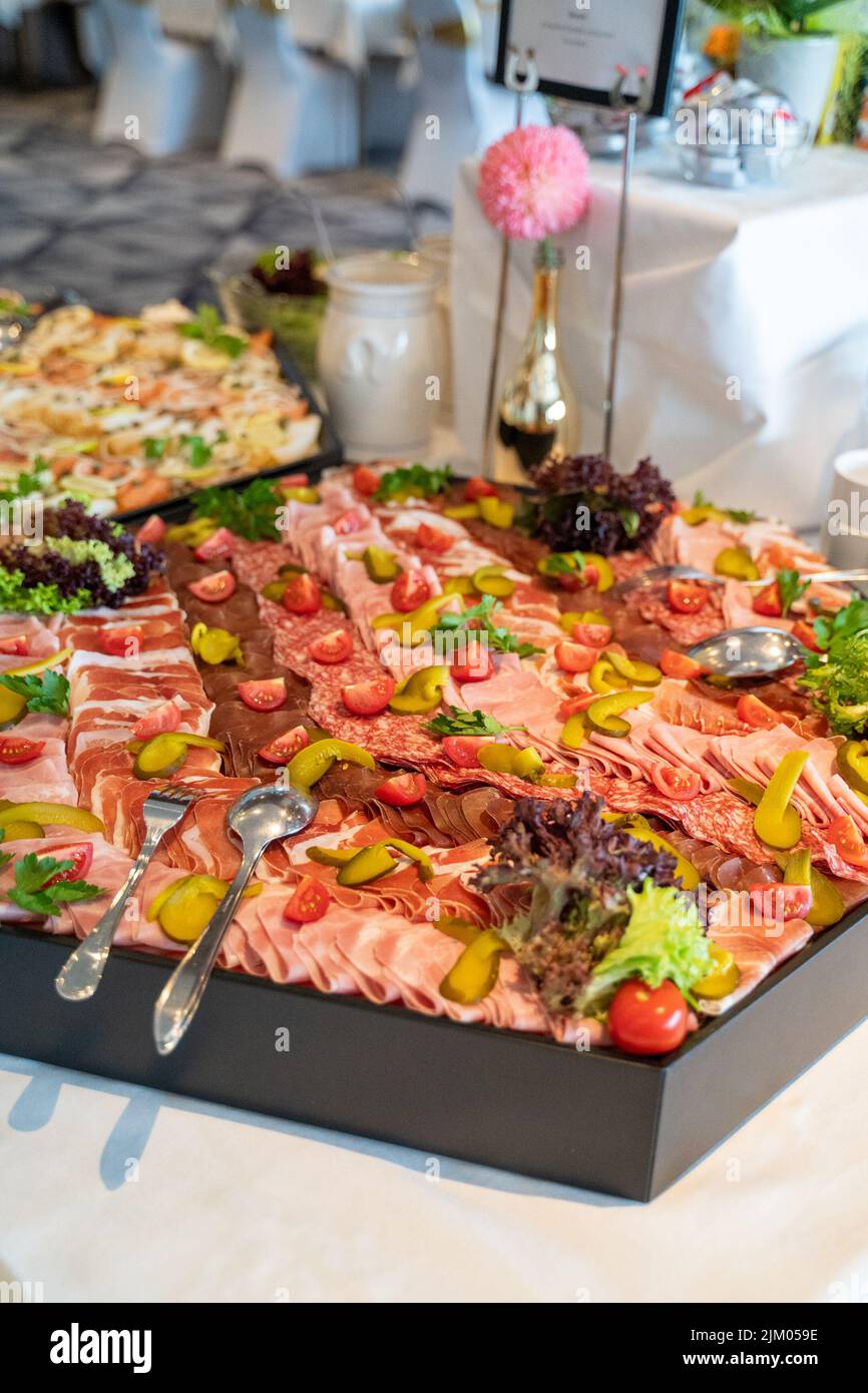 A vertical shot of a meat buffet with a large assortment at a ...