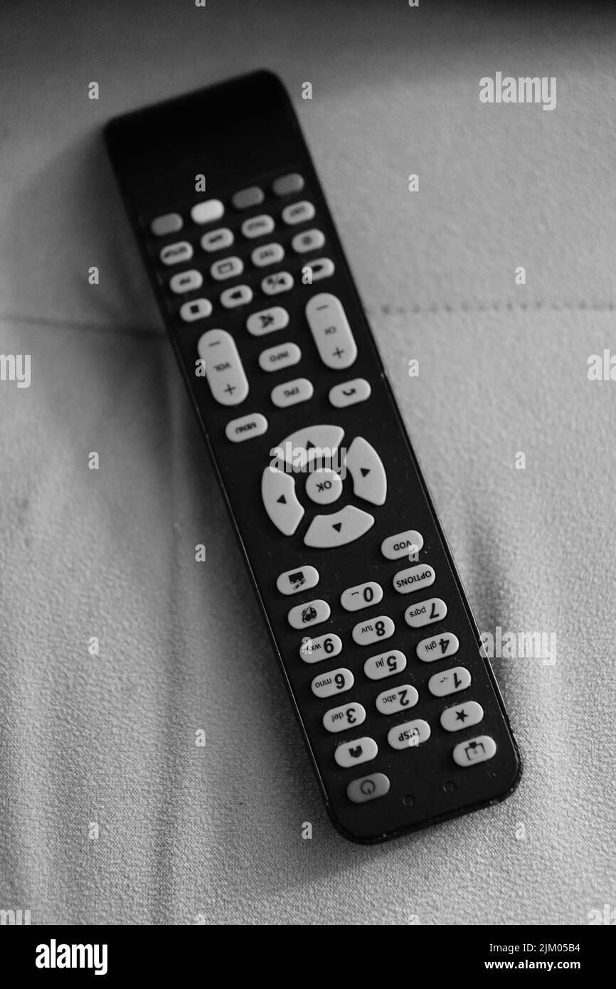 A grayscale of remote control on a white surface Stock Photo - Alamy