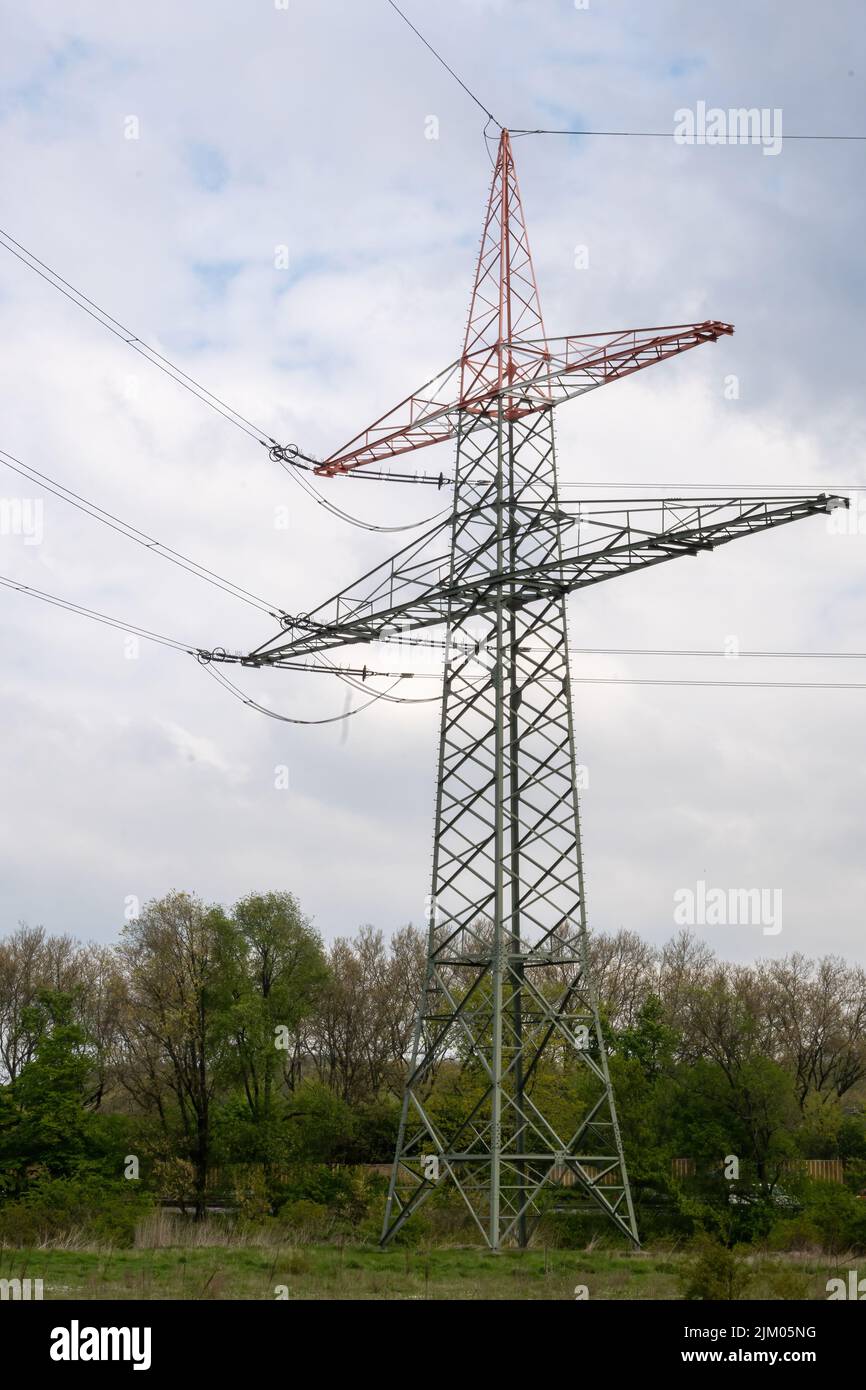 a vertical shot of High voltage pylon for power supply Stock Photo - Alamy