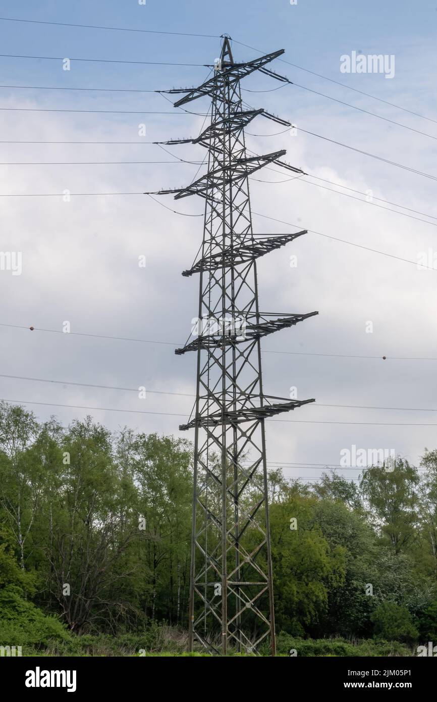 a vertical shot of High voltage pylon for power supply Stock Photo - Alamy