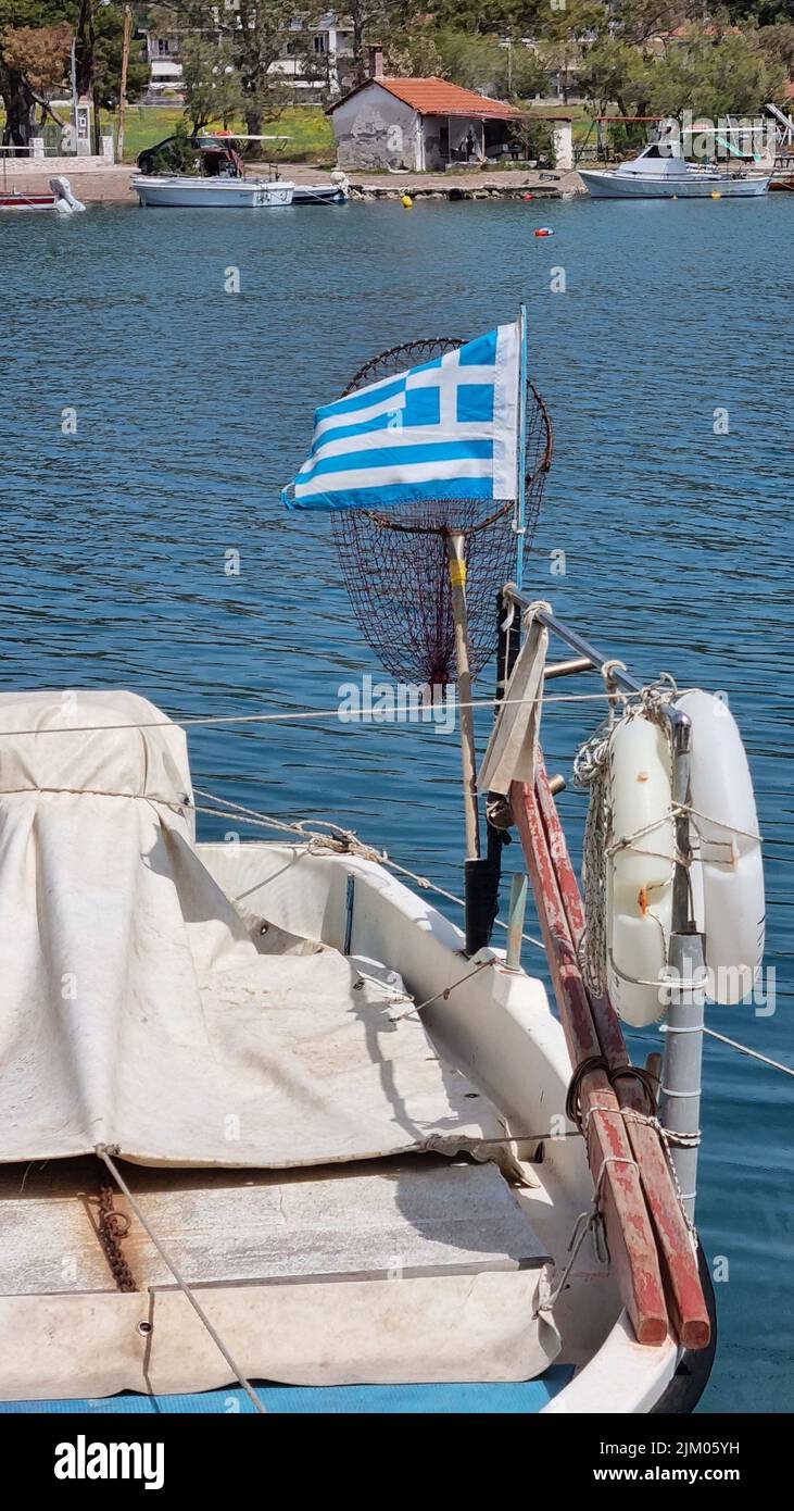 A vertical shot of a Greek boat in the harbor on the Peloponnese ...