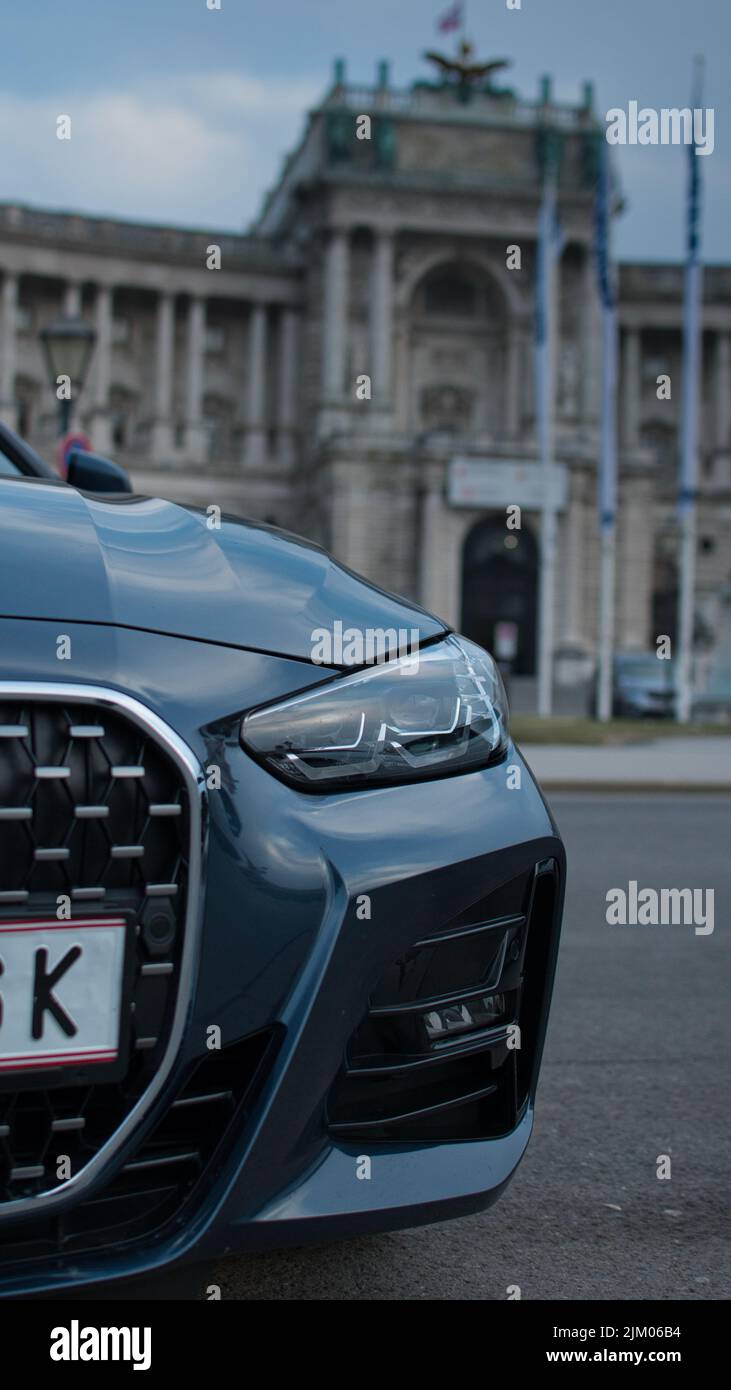 A vertical shot of a front view of a modern grey car headlight with ...