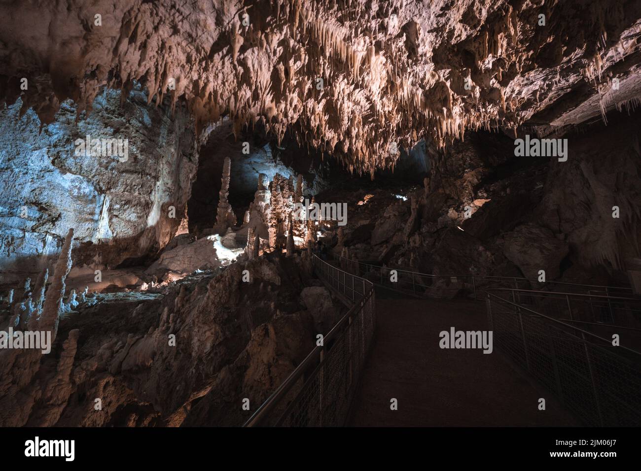 The interior of a cave with rock formations and a tunnel in Spain ...