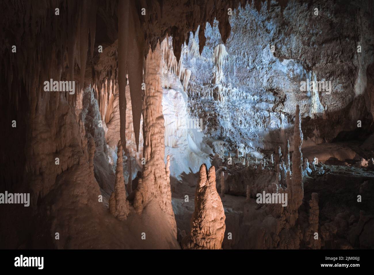 The interior of a cave with rock formations and a tunnel in Spain ...