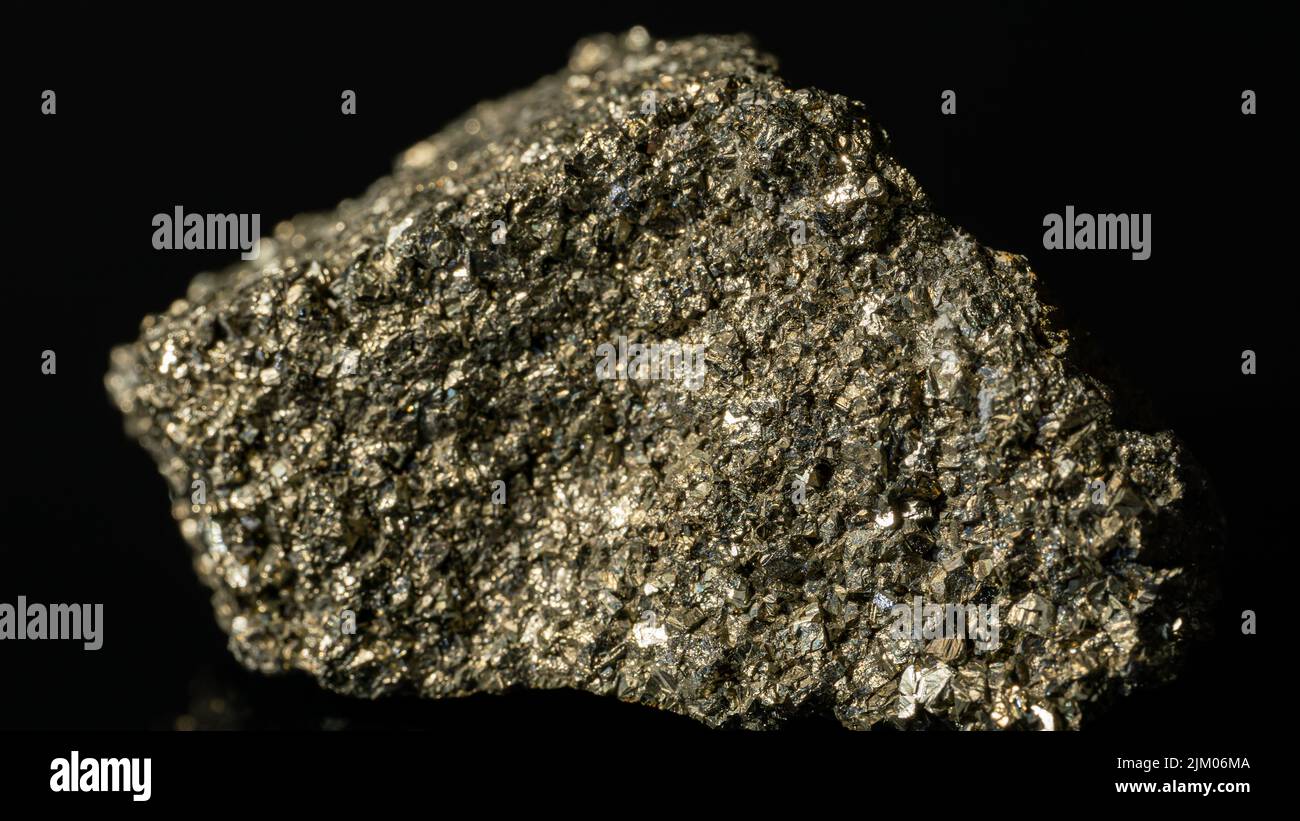 A closeup of a nugget with pyrite mineral crystal isolated on a ...