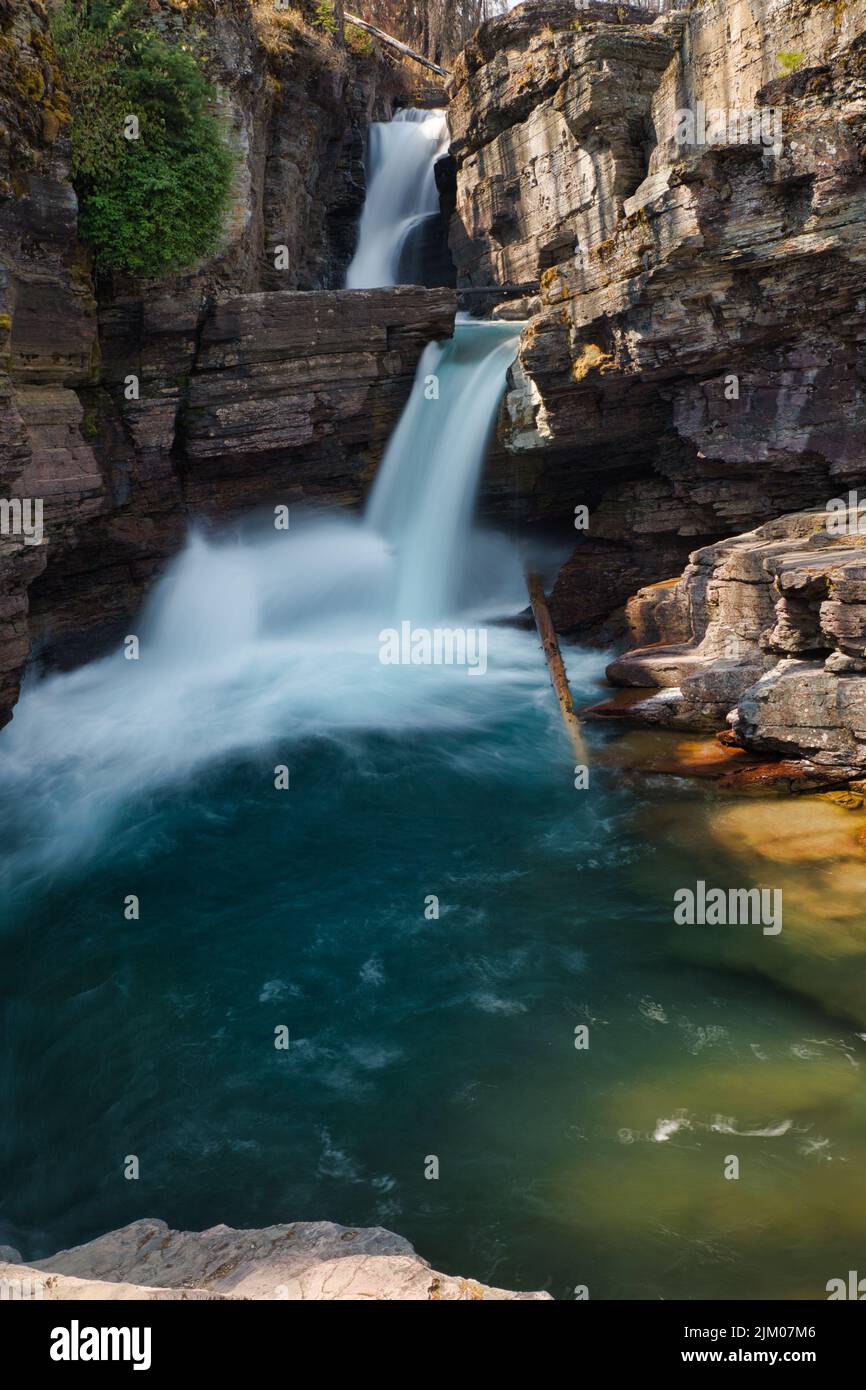 A vertical shot of St Mary Falls in Glacier National Park, Montana ...