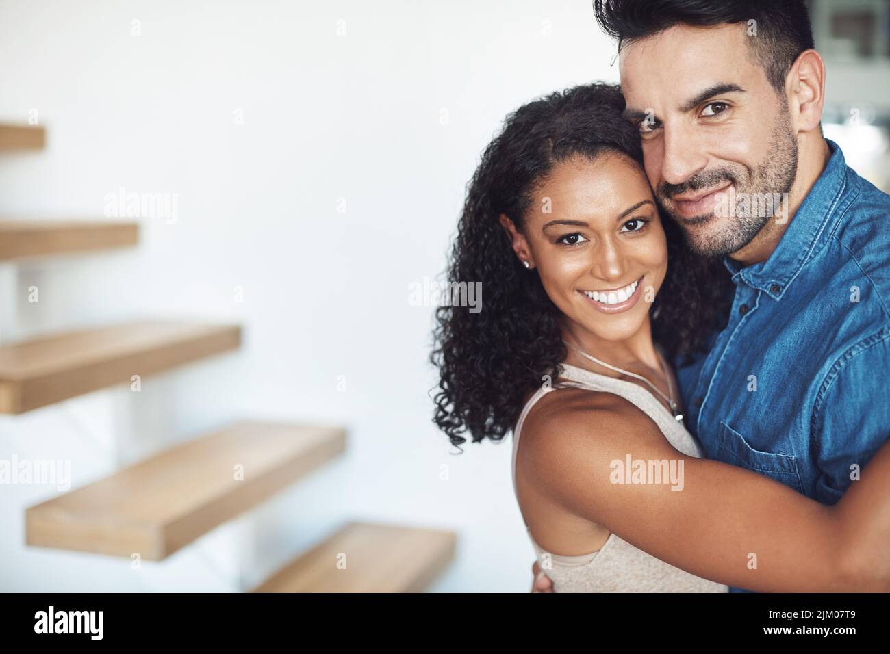 Hugging, love and affection couple loving, happy and smiling. Interracial boyfriend and ...