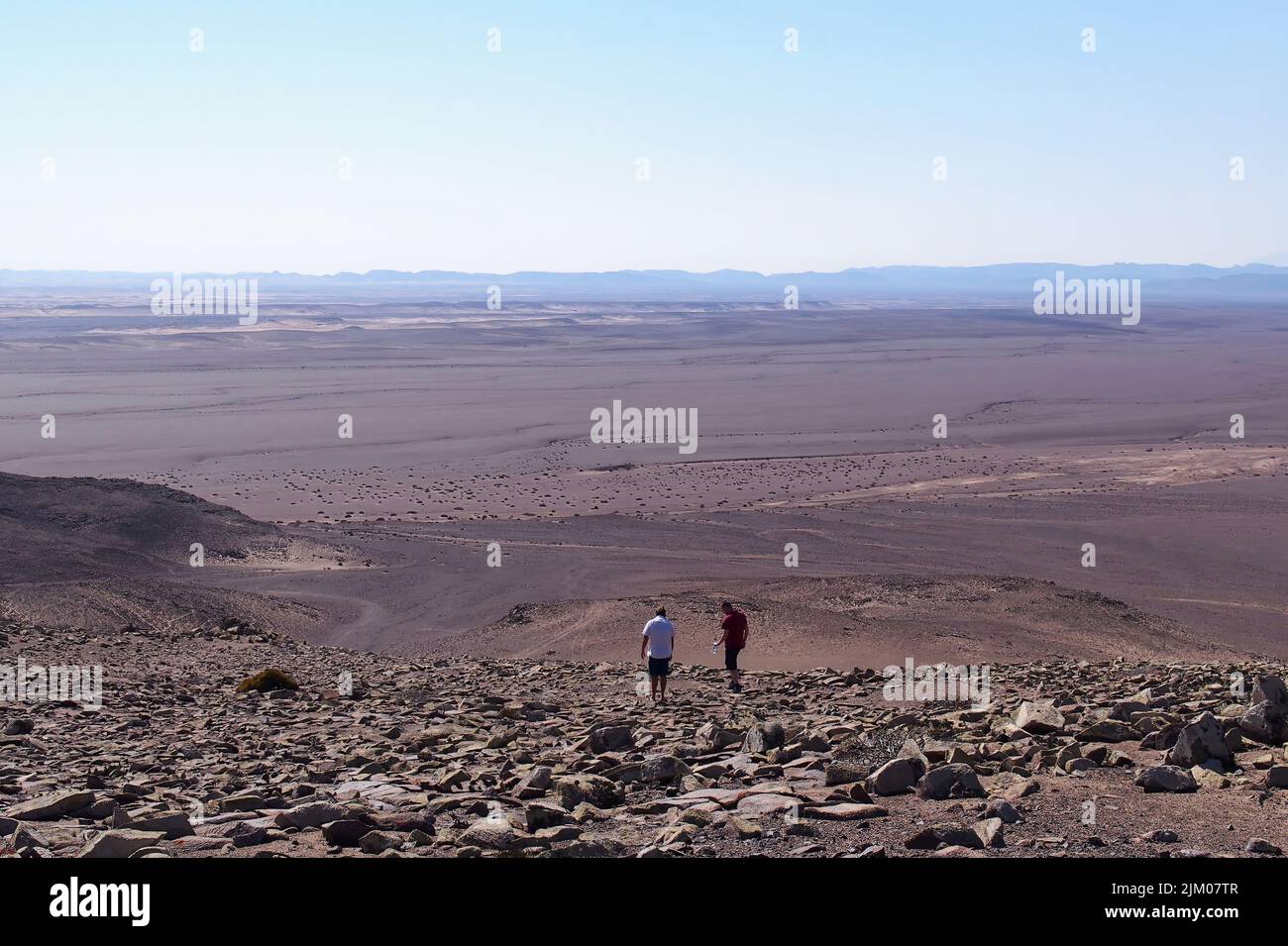 A distant view of people standing at the Messum Crater in Damaraland ...