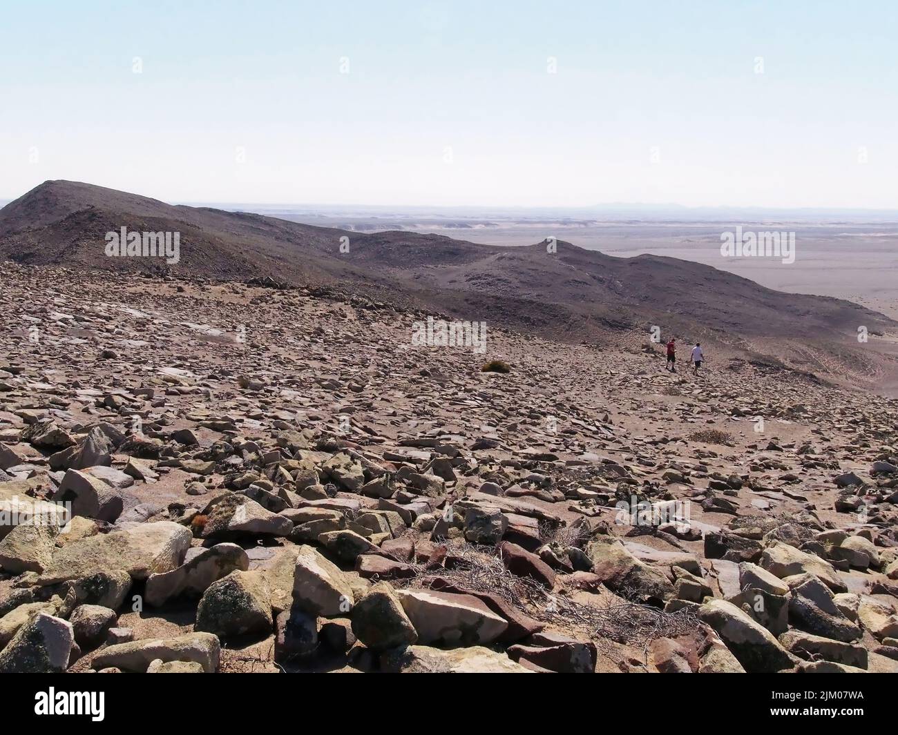 A distant view of two males walking at the Messum Crater, Damaraland ...