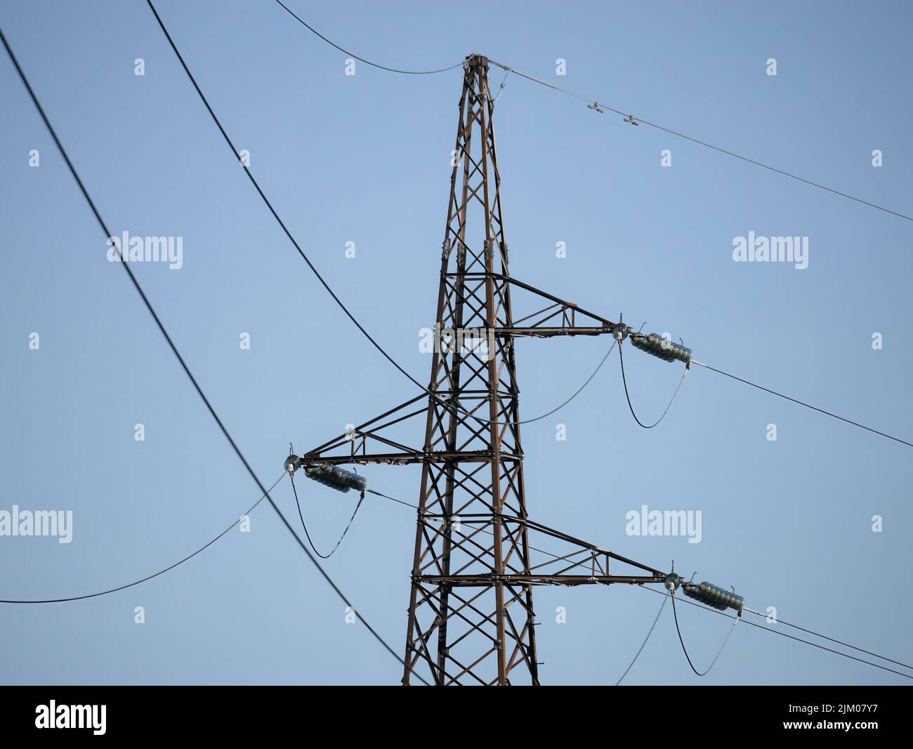 A closeup of a dead-end tower or anchor pylon against the blue sky ...