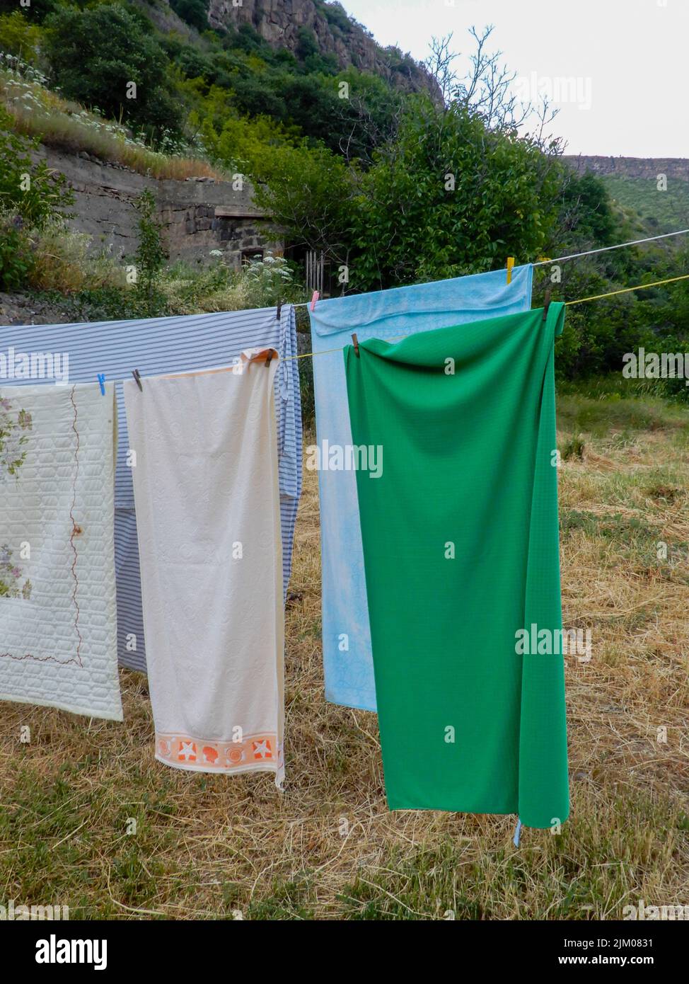 The sheets drying on a clothesline with mountain on the background ...