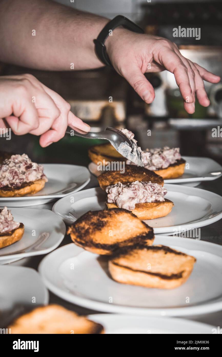Chef finishing her plate and almost ready to serve at the table. Only ...