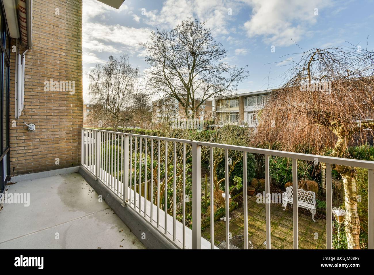 Front view of old brick buildings and cars with bicycles from small ...