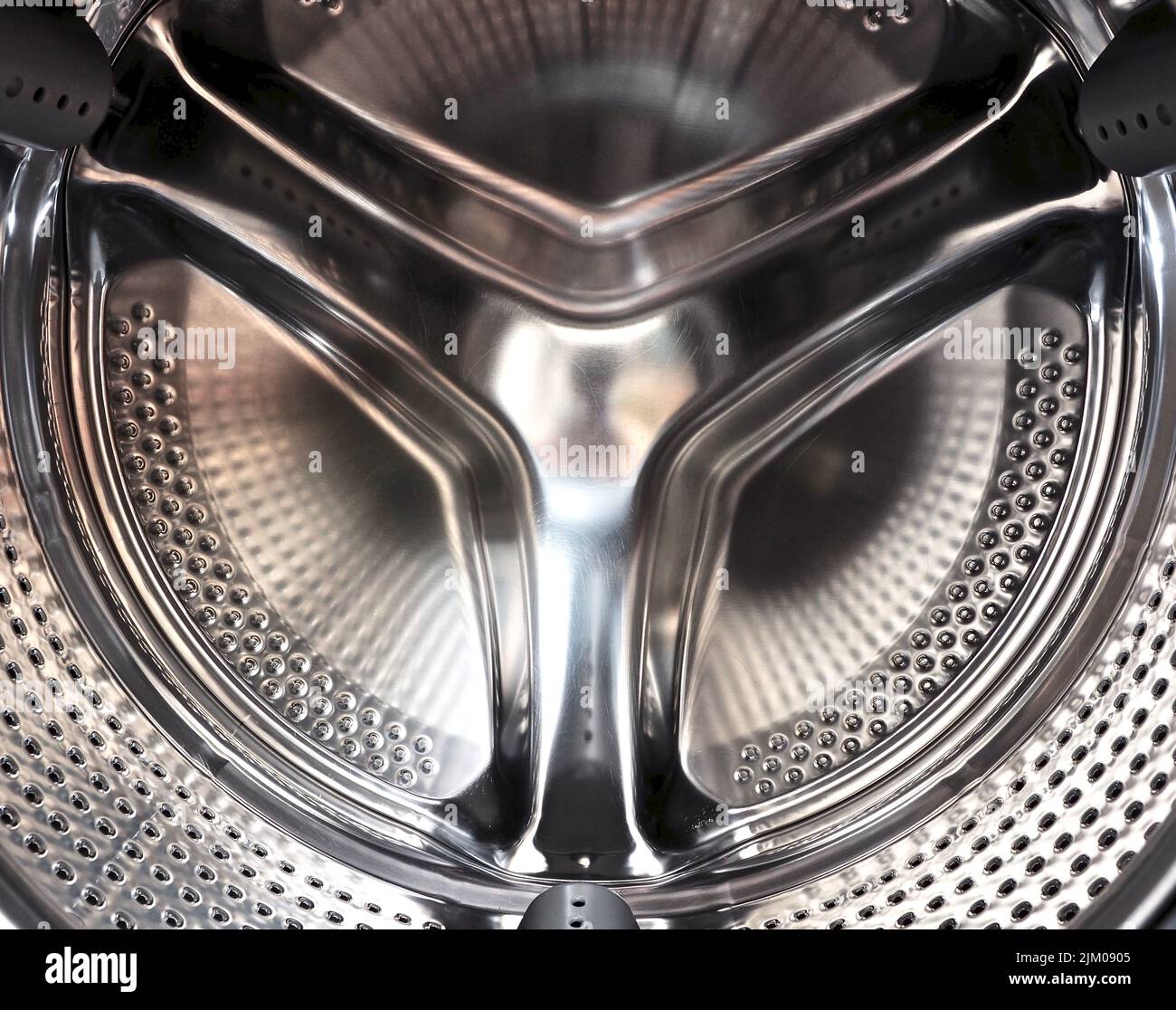 close up of a washing machine steel drum, symmetrical horizontal vie ...
