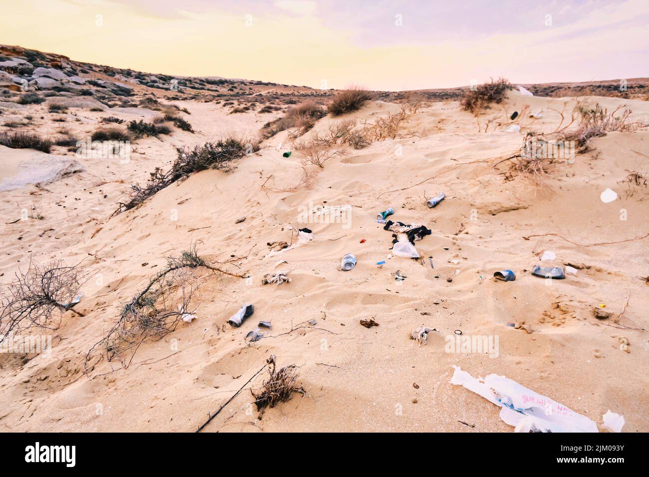 A view of trash on the beach during sunrise Stock Photo - Alamy