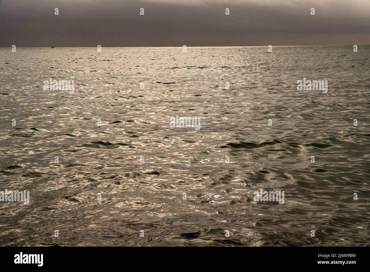 A scenic view of a vast ocean in cloudy sky background Stock Photo - Alamy