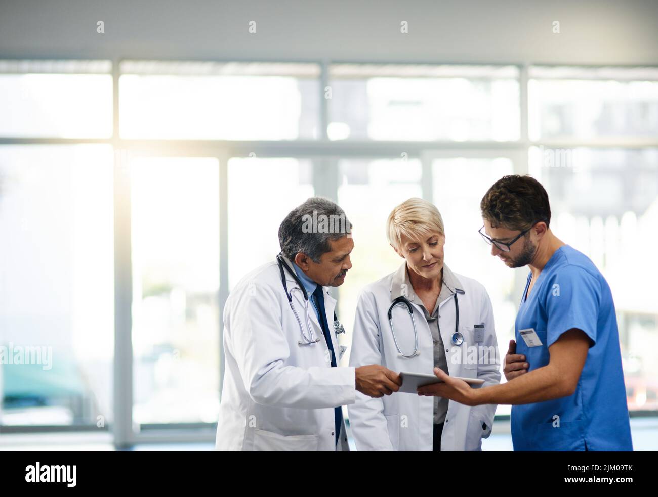 Team or group of doctors, nurses and medical professional talking ...