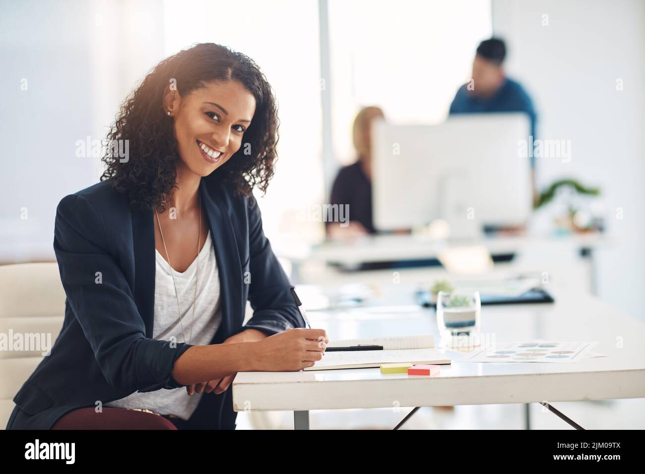 Happy corporate business woman working at her desk, doing admin and ...