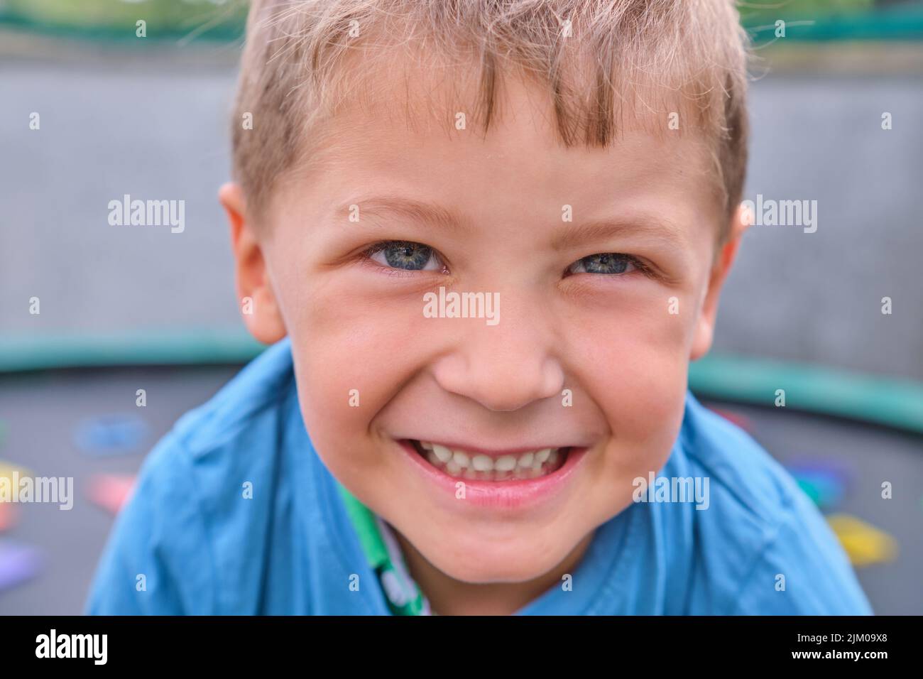 Smiling face portrait small child blue Eye contact close up looking to ...