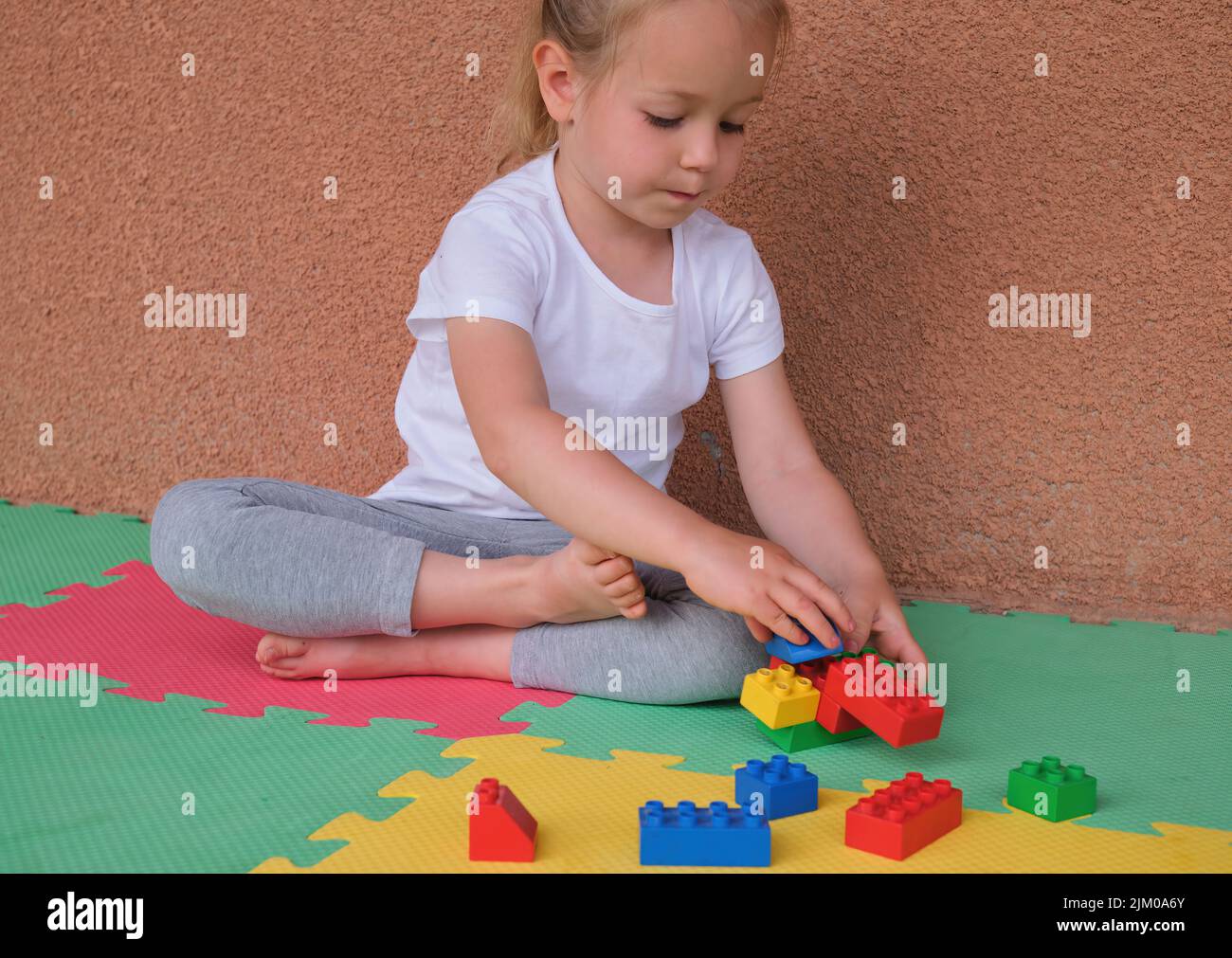 child little girl playing building blocks lego constructor bricks toys ...