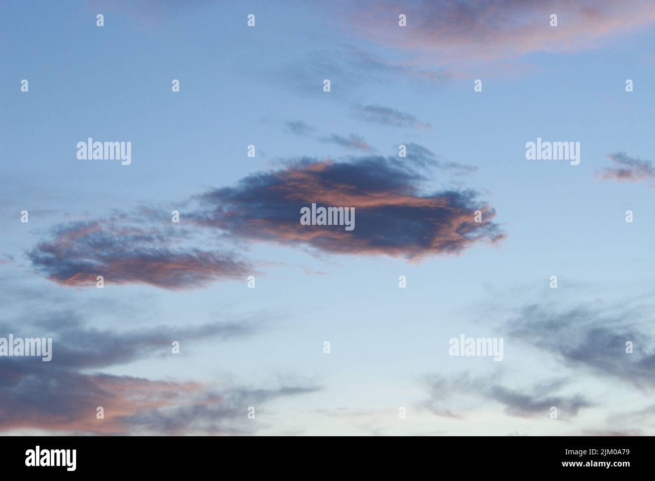 A natural landscape of clouds under a pink sunset sky Stock Photo - Alamy