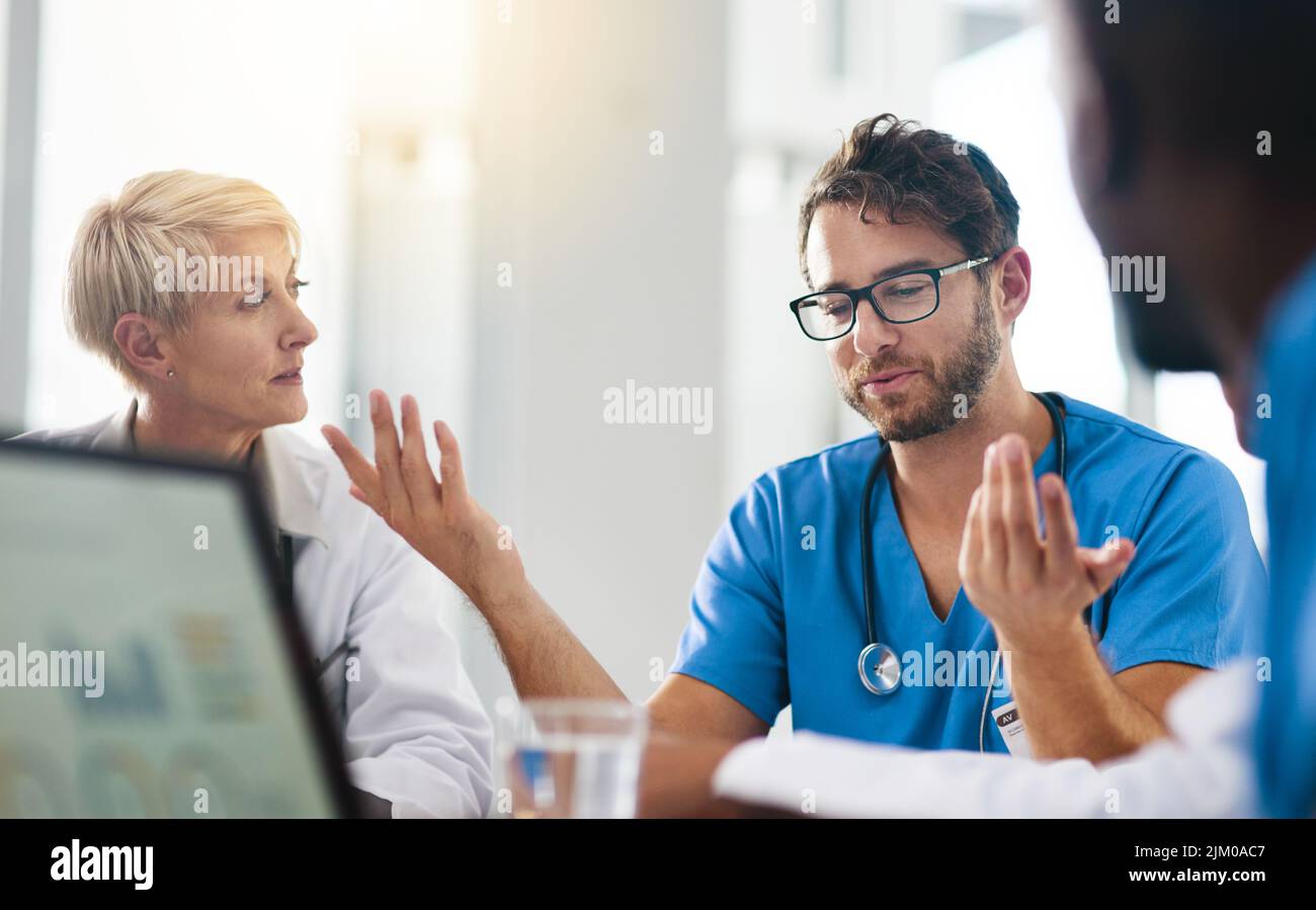 Group of medical doctors planning, brainstorming and discussing ...