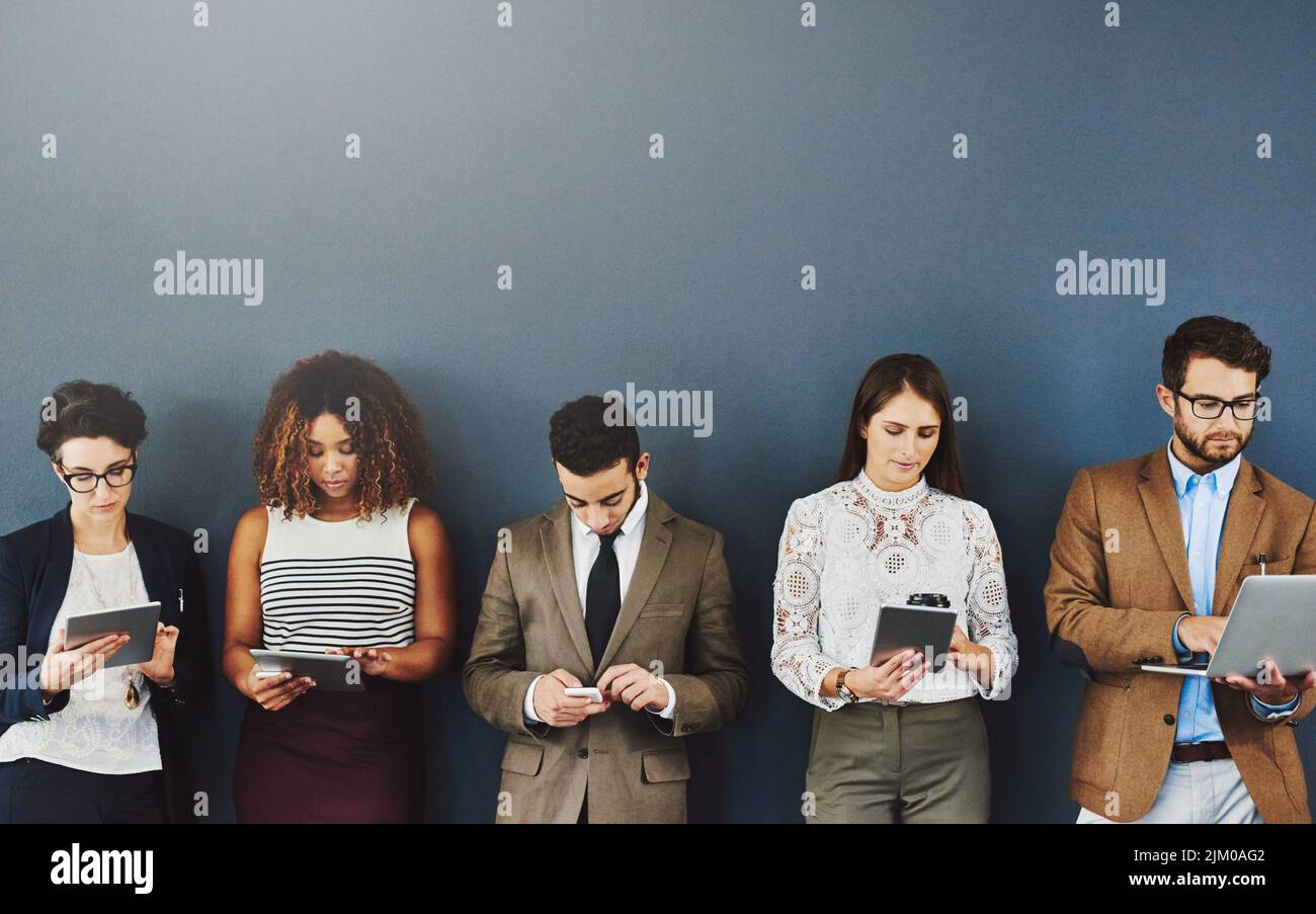 Group of businesspeople texting, typing and browsing online while ...