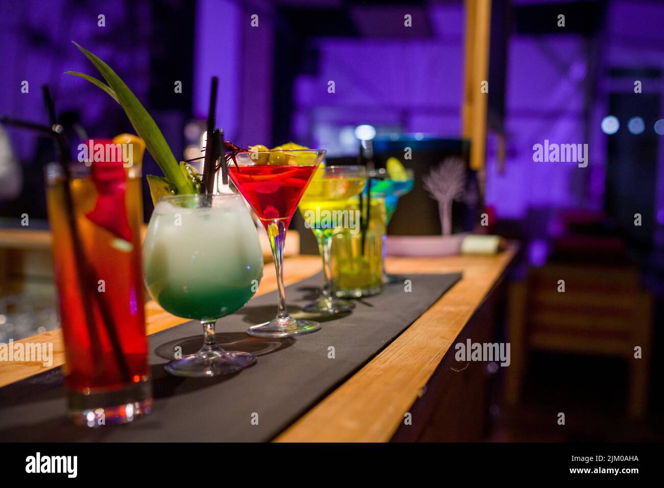 A row of different martini glasses on the counter in a bar Stock Photo ...