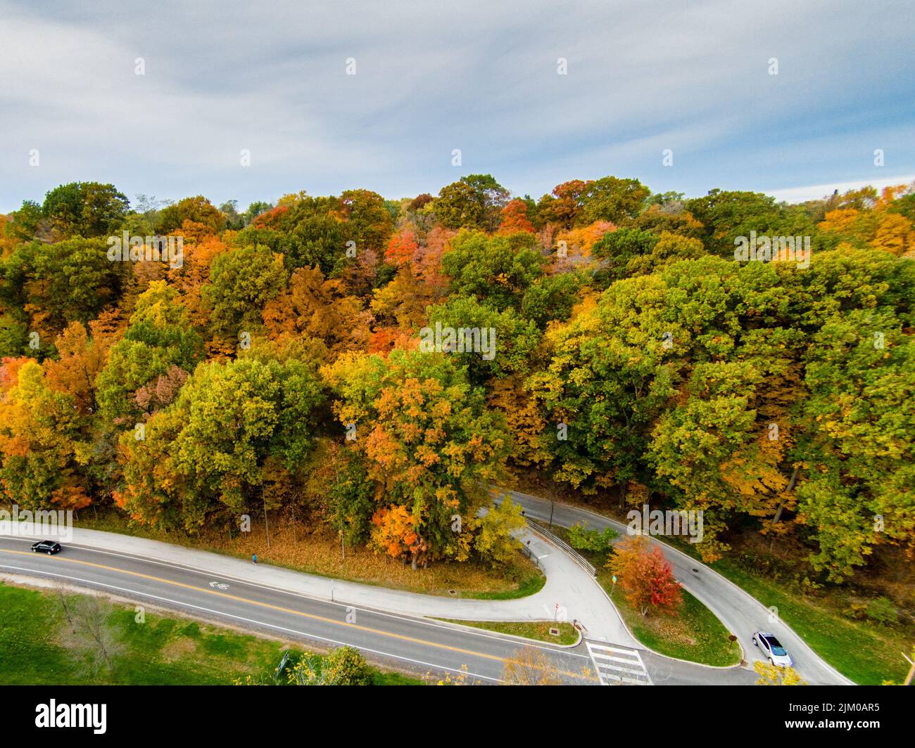 The view of the roads surrounded by colorful trees. Autumn landscape ...