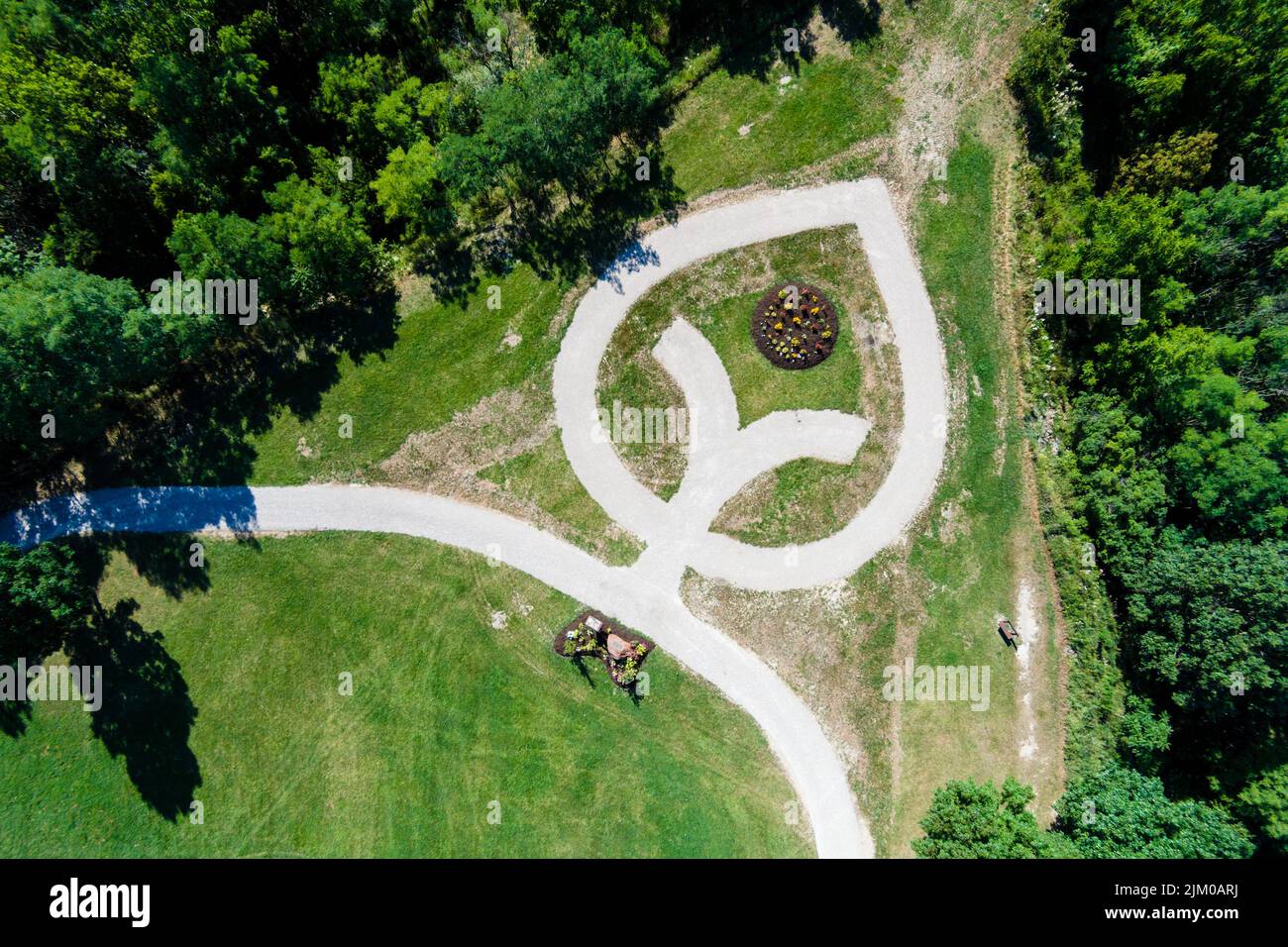 The bird's eye view of the green park with a white pattern on the lawn ...