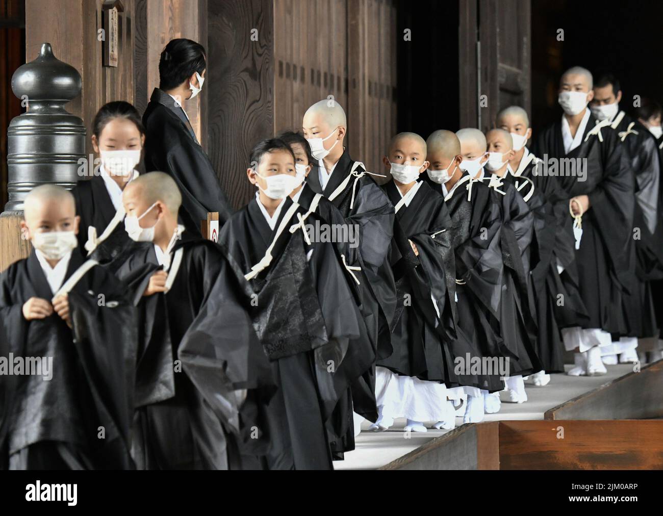 Children wearing face masks amid the novel coronavirus pandemic are ...