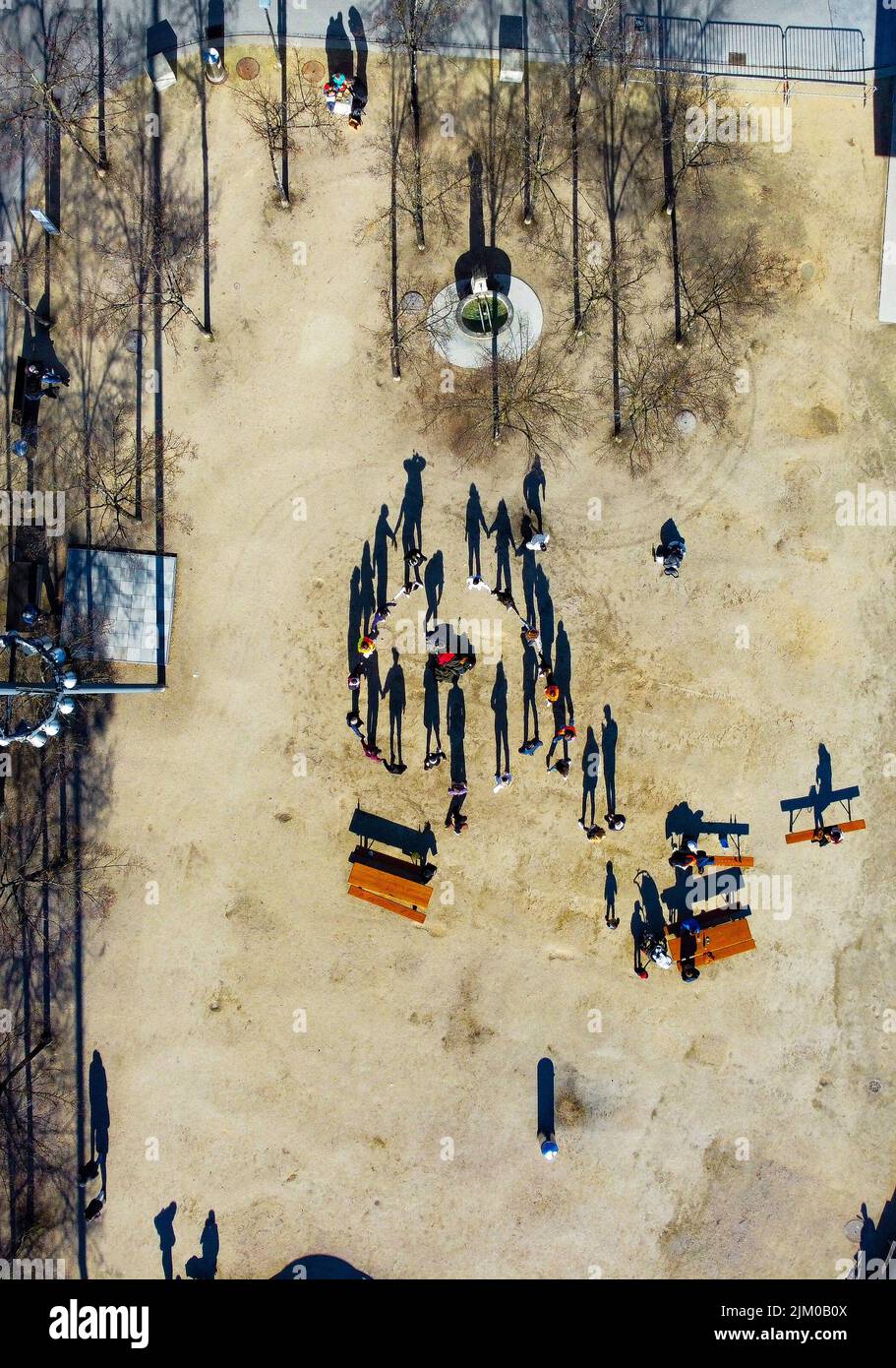 The vertical aerial shot of a group of people gathered together in a ...