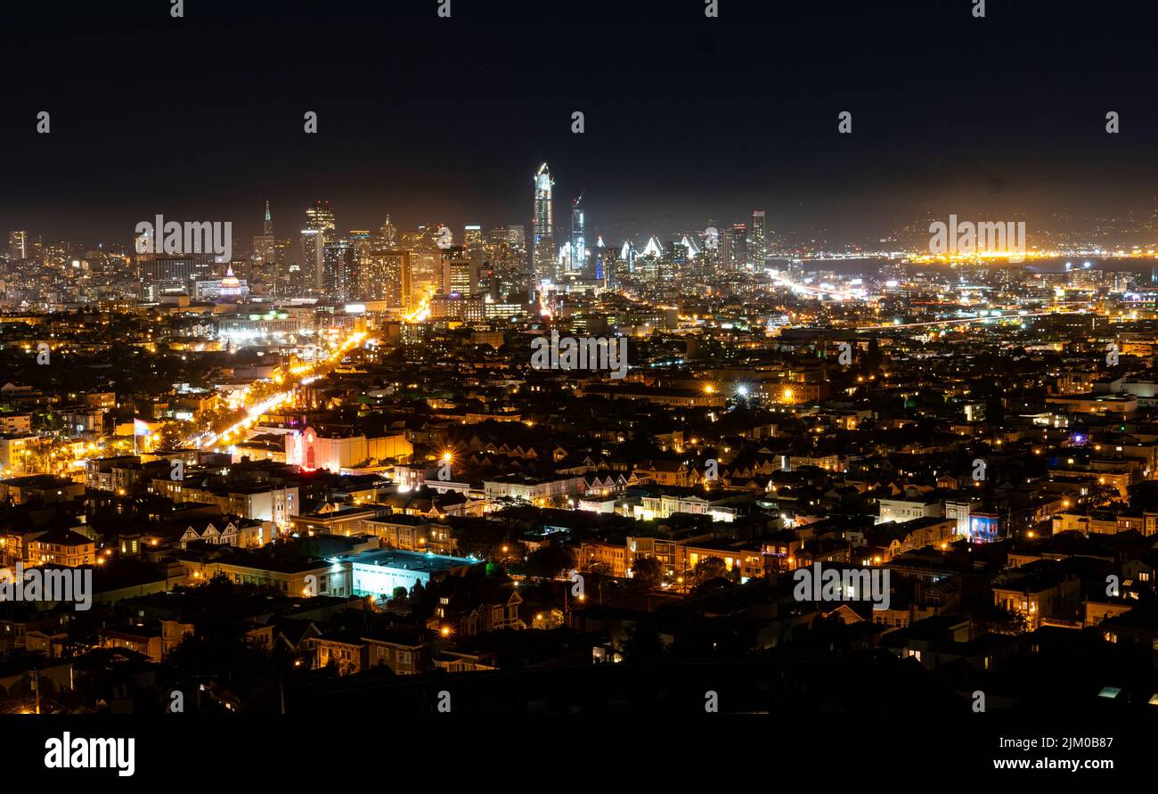 An aerial view of the illuminated skyline at night in San Francisco ...
