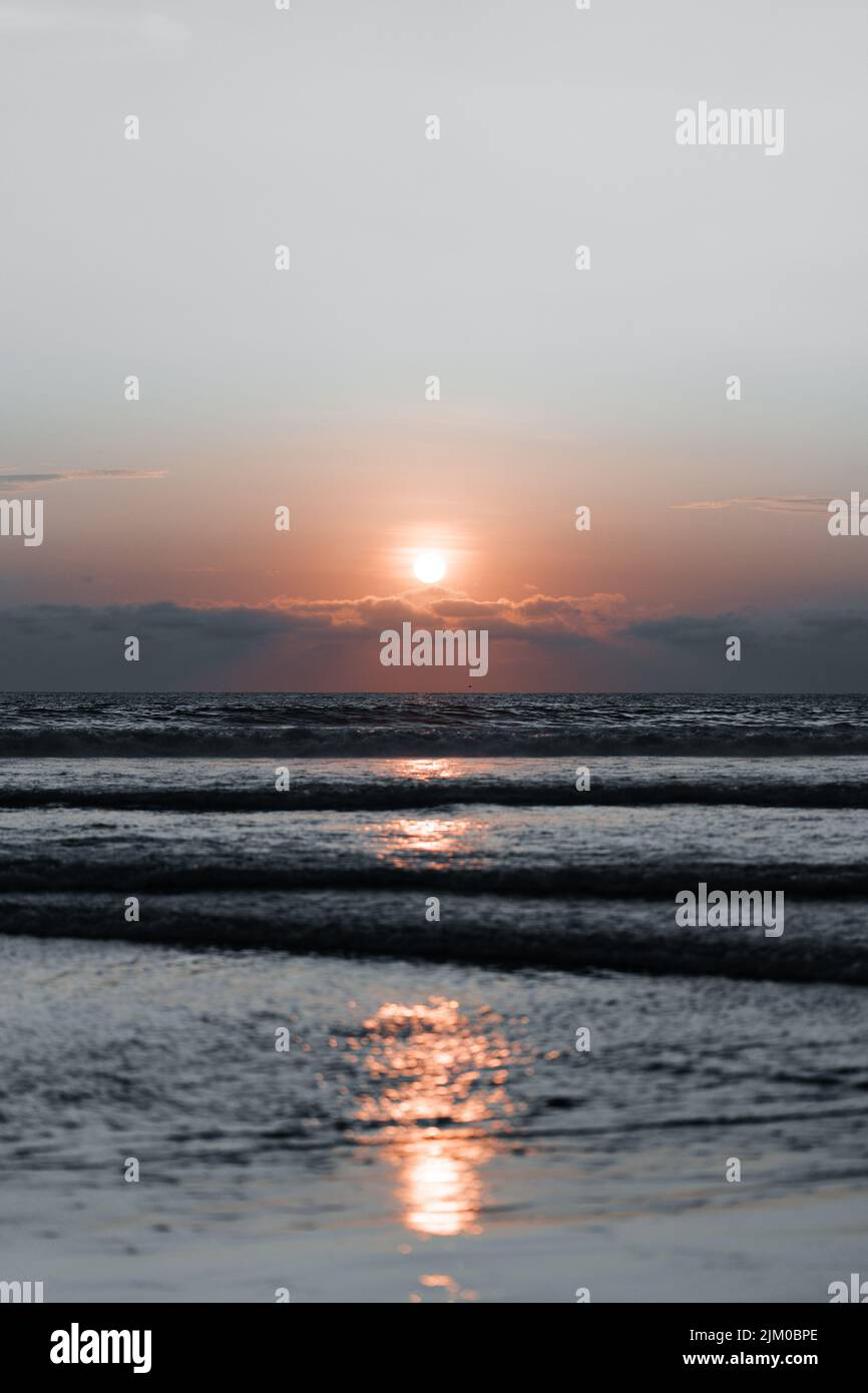 A beautiful view of sunset over an ocean Stock Photo - Alamy