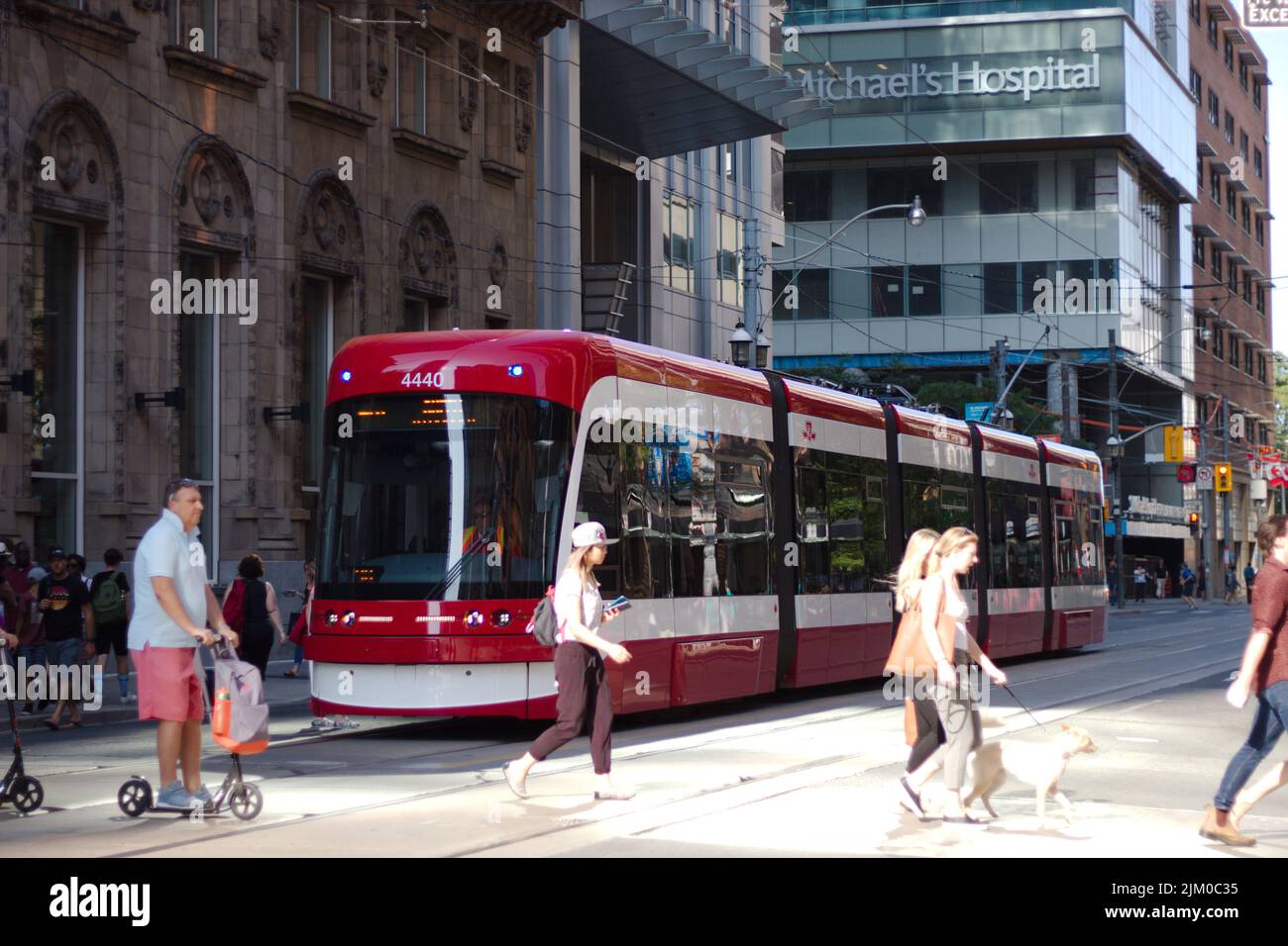 A beautiful shot of public red bus transport and people crossing the ...